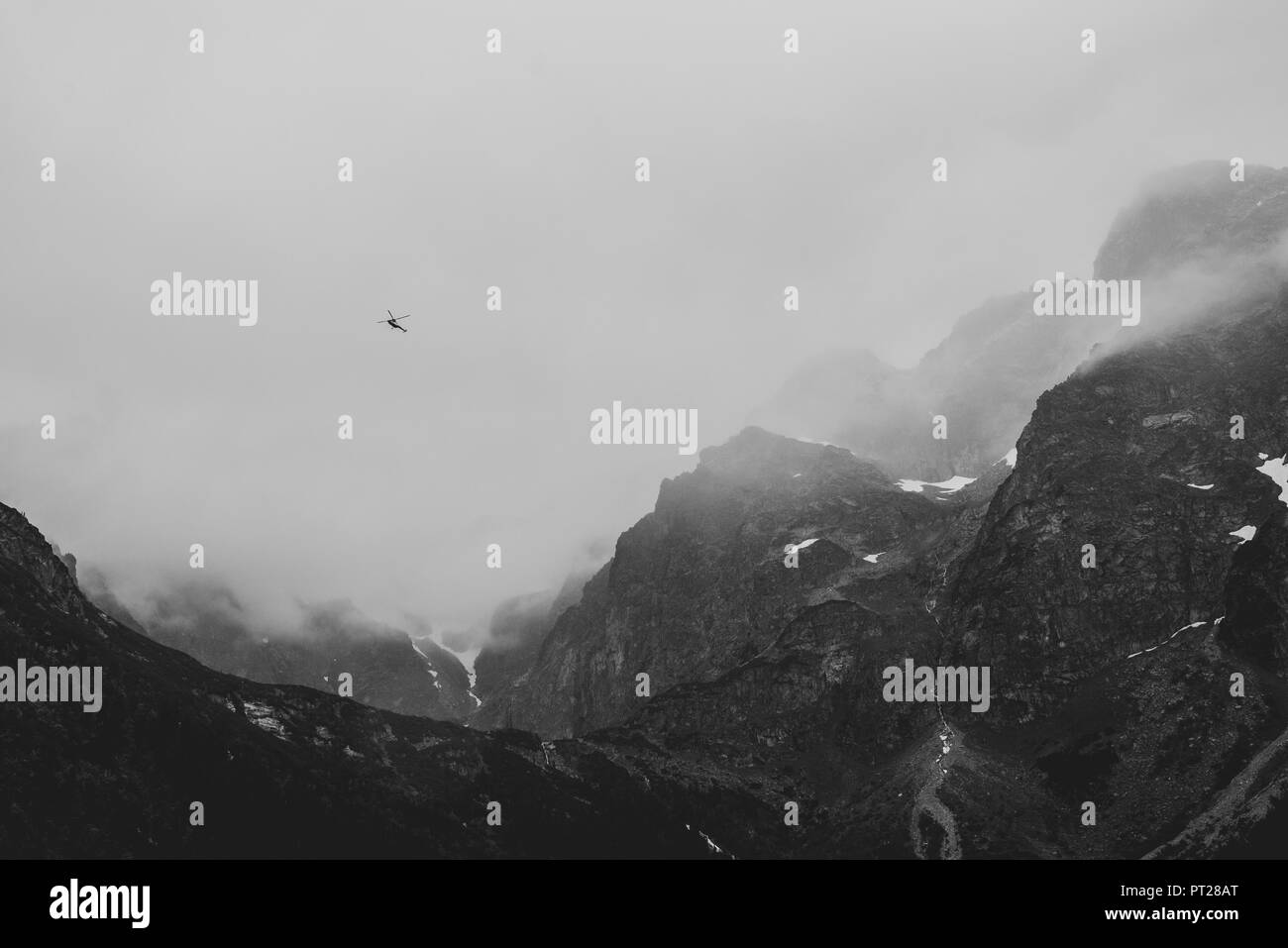 rescue helicopter in the mountains, heavy fog, Tatra Stock Photo - Alamy
