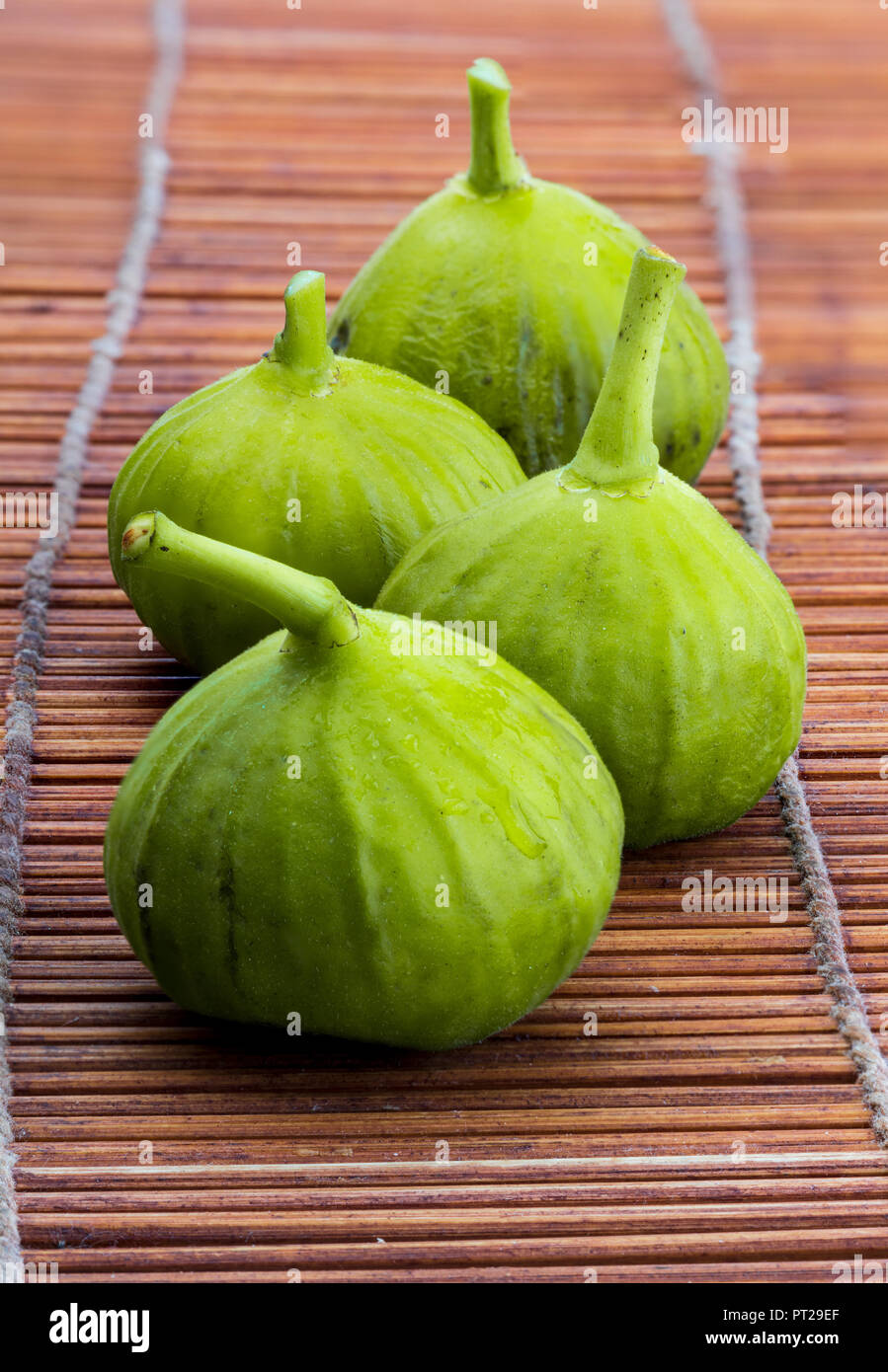 Green figs, fresh and ripe. With a fig leaf Wood background Stock Photo ...