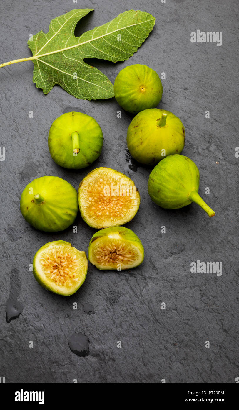 Green figs, fresh and ripe. With a fig leaf Wood background Stock Photo ...
