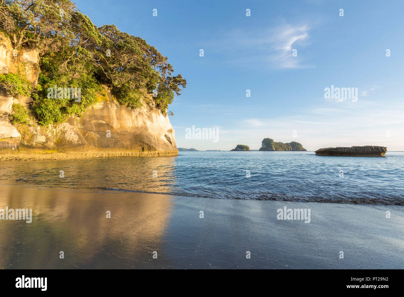 Cave tunnel rock at Cathedral Cove, with Poikeke and Motueka islands in ...