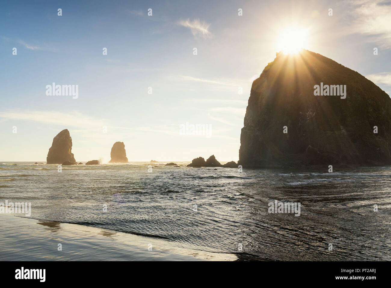 Pacific Coast, Cannon Beach, Haystack Rock with sunbeams Stock Photo ...