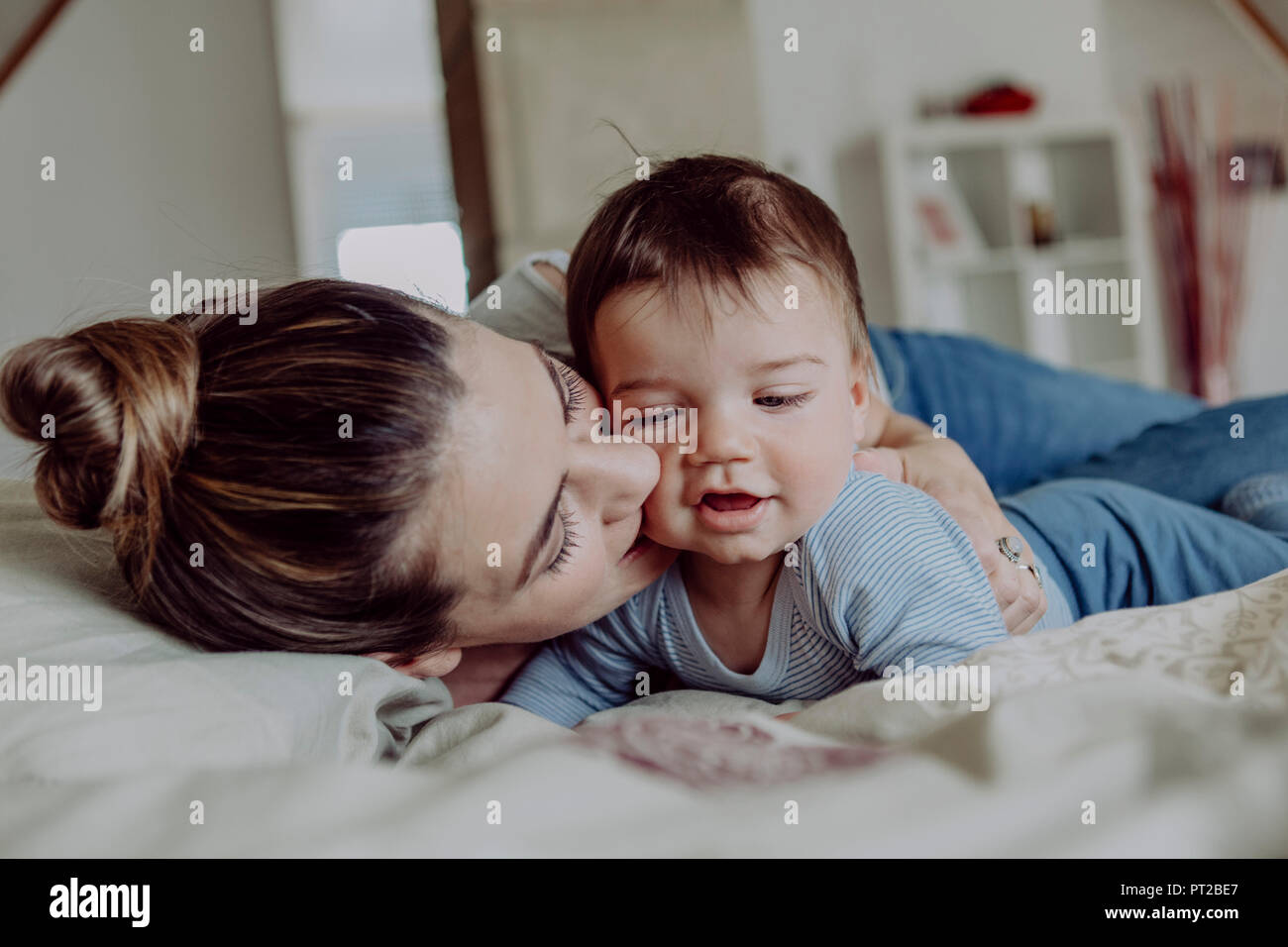 Mother cuddling with her baby son Stock Photo - Alamy