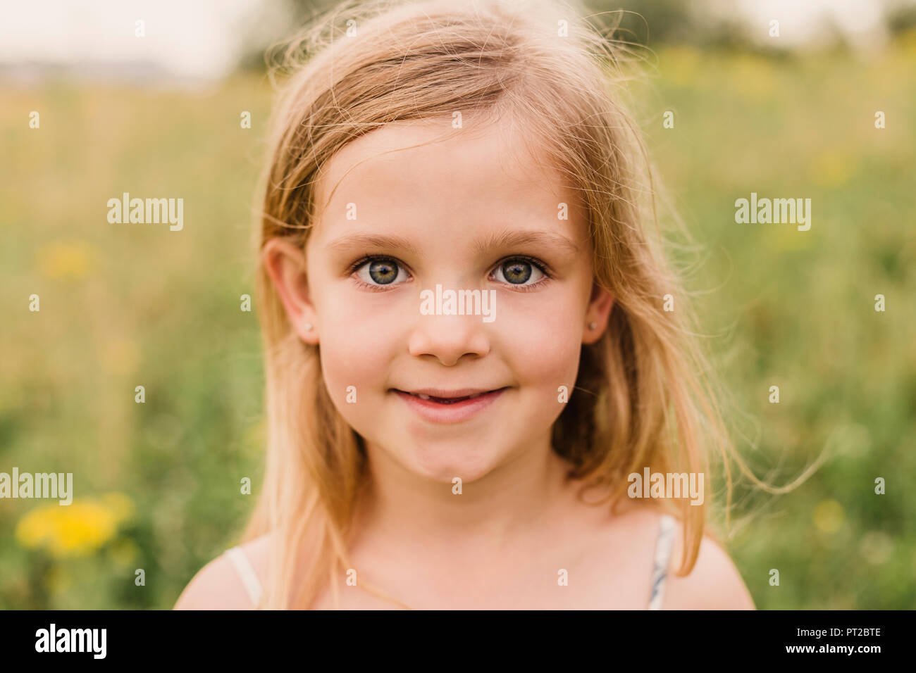 Portrait of blond little girl in nature Stock Photo - Alamy