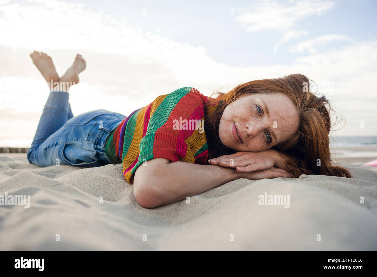 Beautiful woman laying on beach hi-res stock photography and images - Alamy