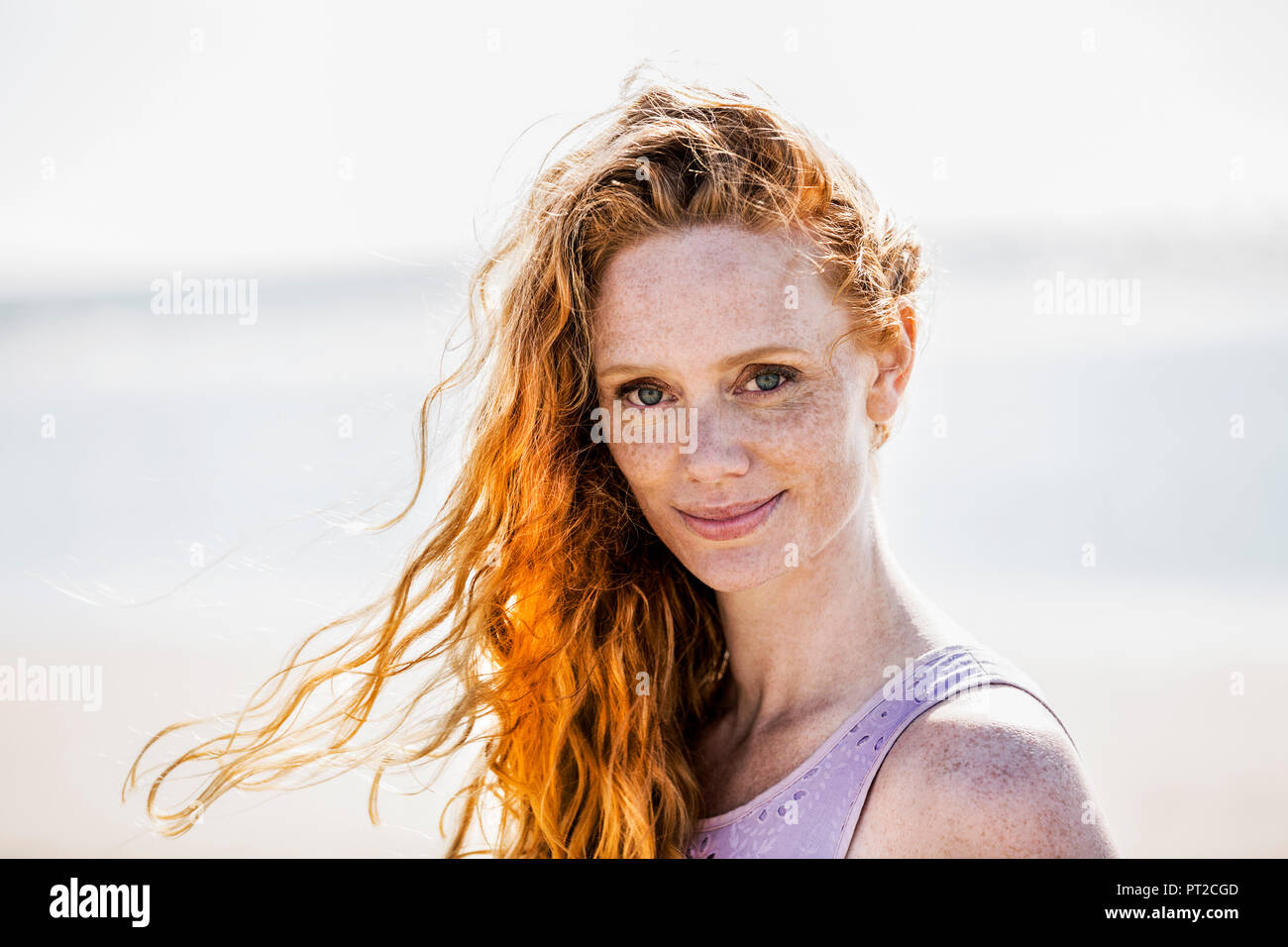 Portrait of smiling redheaded woman outdoors Stock Photo - Alamy