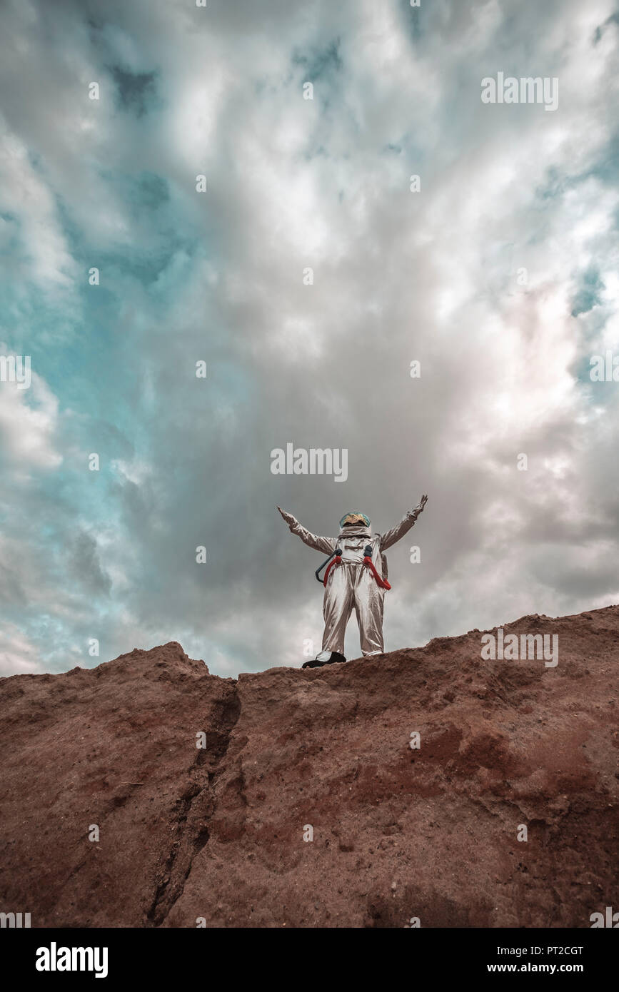 Spaceman standing on slope of nameless planet Stock Photo - Alamy