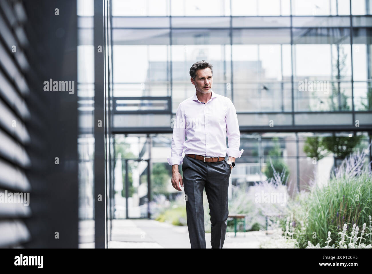 Businessmen walking out office building hi-res stock photography and ...