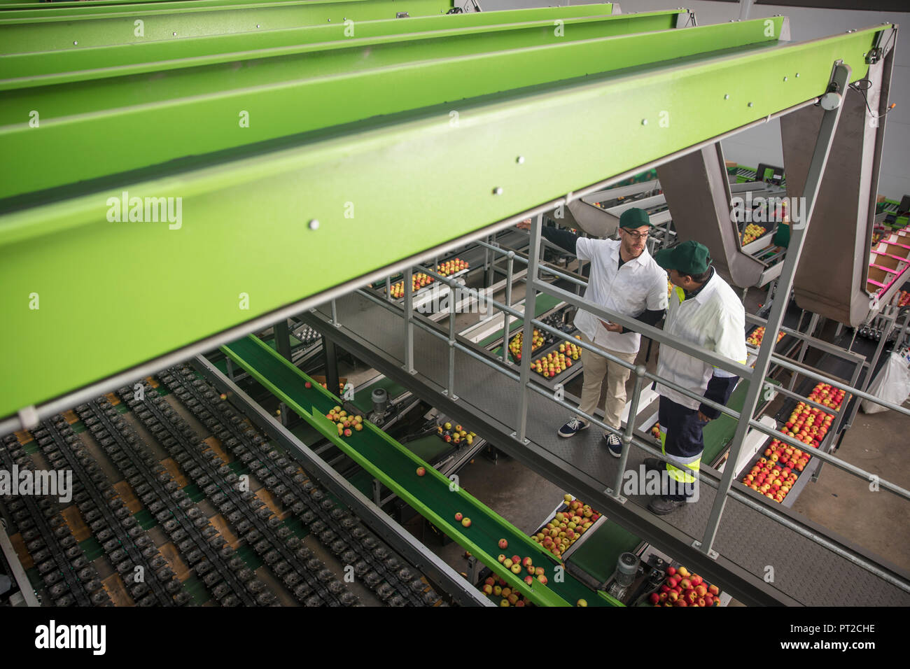 Workers talking apple factory hi-res stock photography and images - Alamy