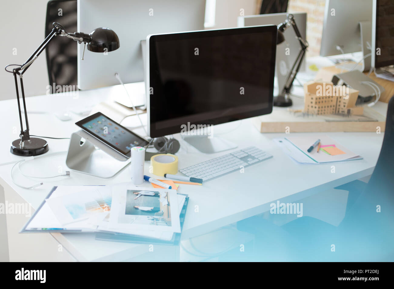 Desk with computer, photo and documents in office Stock Photo - Alamy