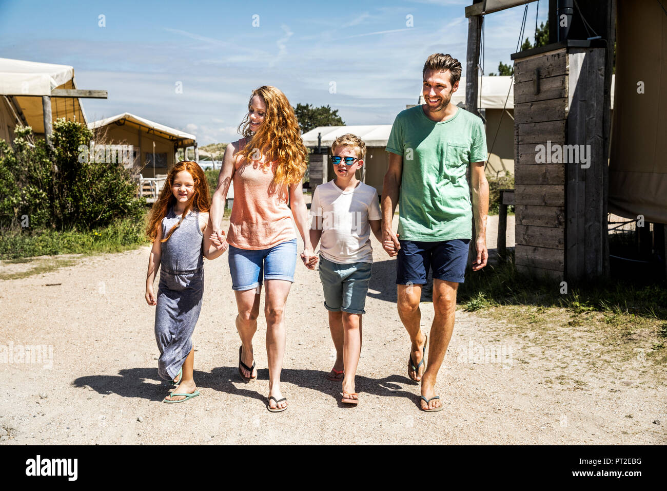 Netherlands, Zandvoort, happy family walking on campsite Stock Photo ...