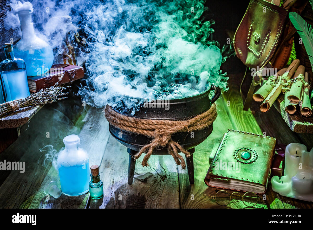 Mysterious witch pot with potions, books and scrolls for Halloween ...