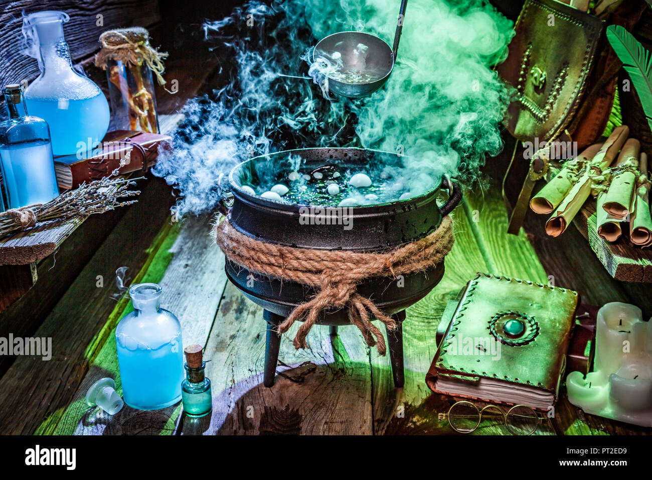 Witcher hut with blue and green smoke for Halloween Stock Photo - Alamy
