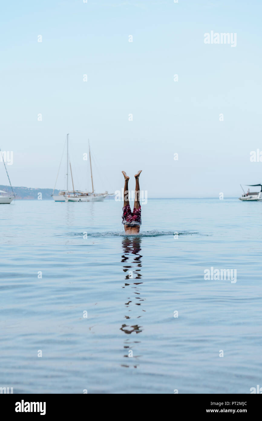 Man doing handstand in water Stock Photo - Alamy