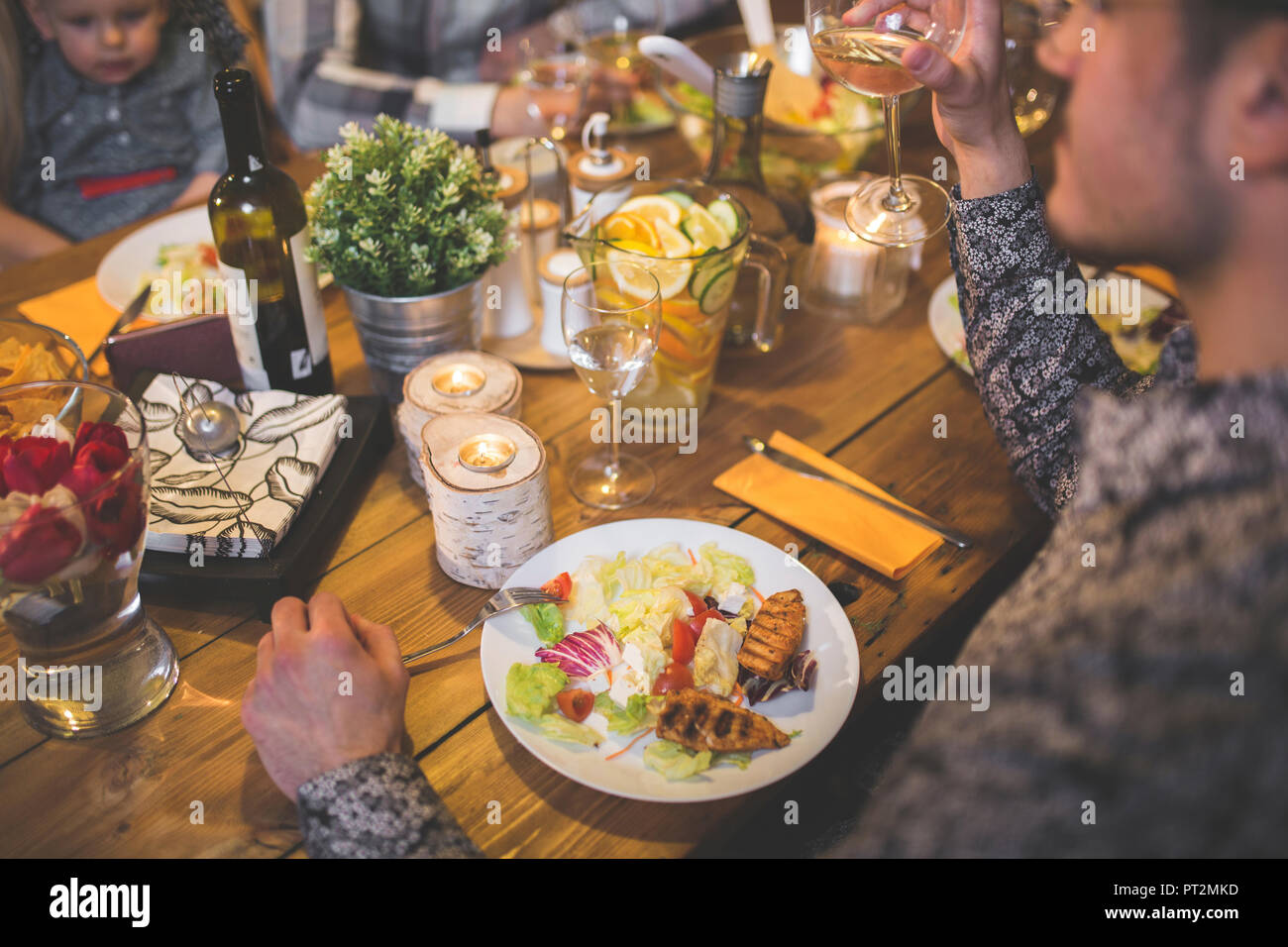 Family and friends enjoying dinner, eating, drinking, having fun Stock ...