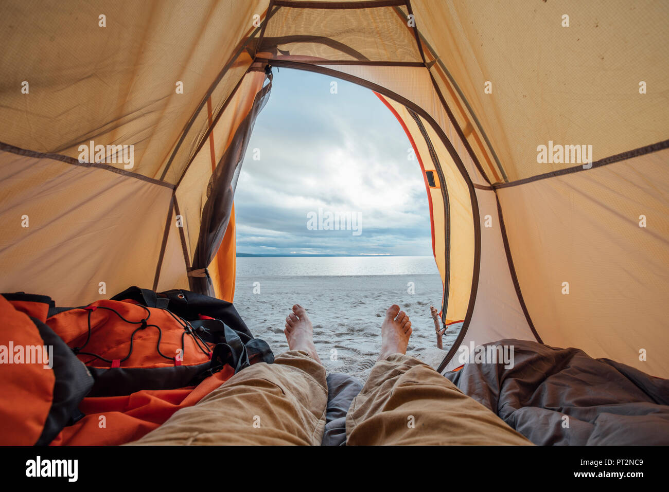 Feet of man, lying in tent on beach Stock Photo - Alamy
