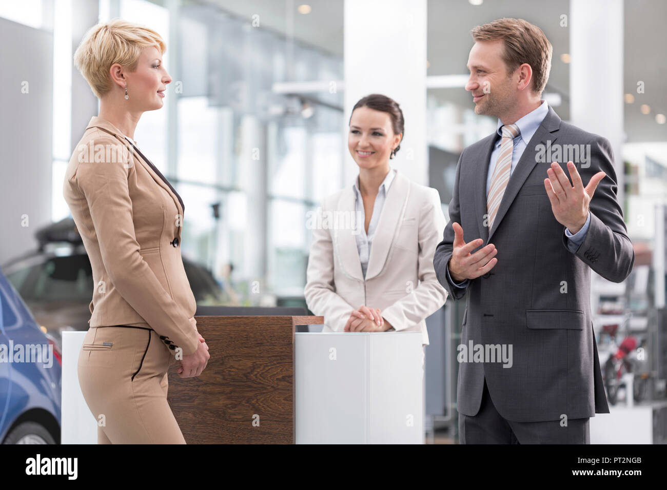 At the car dealer, Salesman talking to client Stock Photo - Alamy