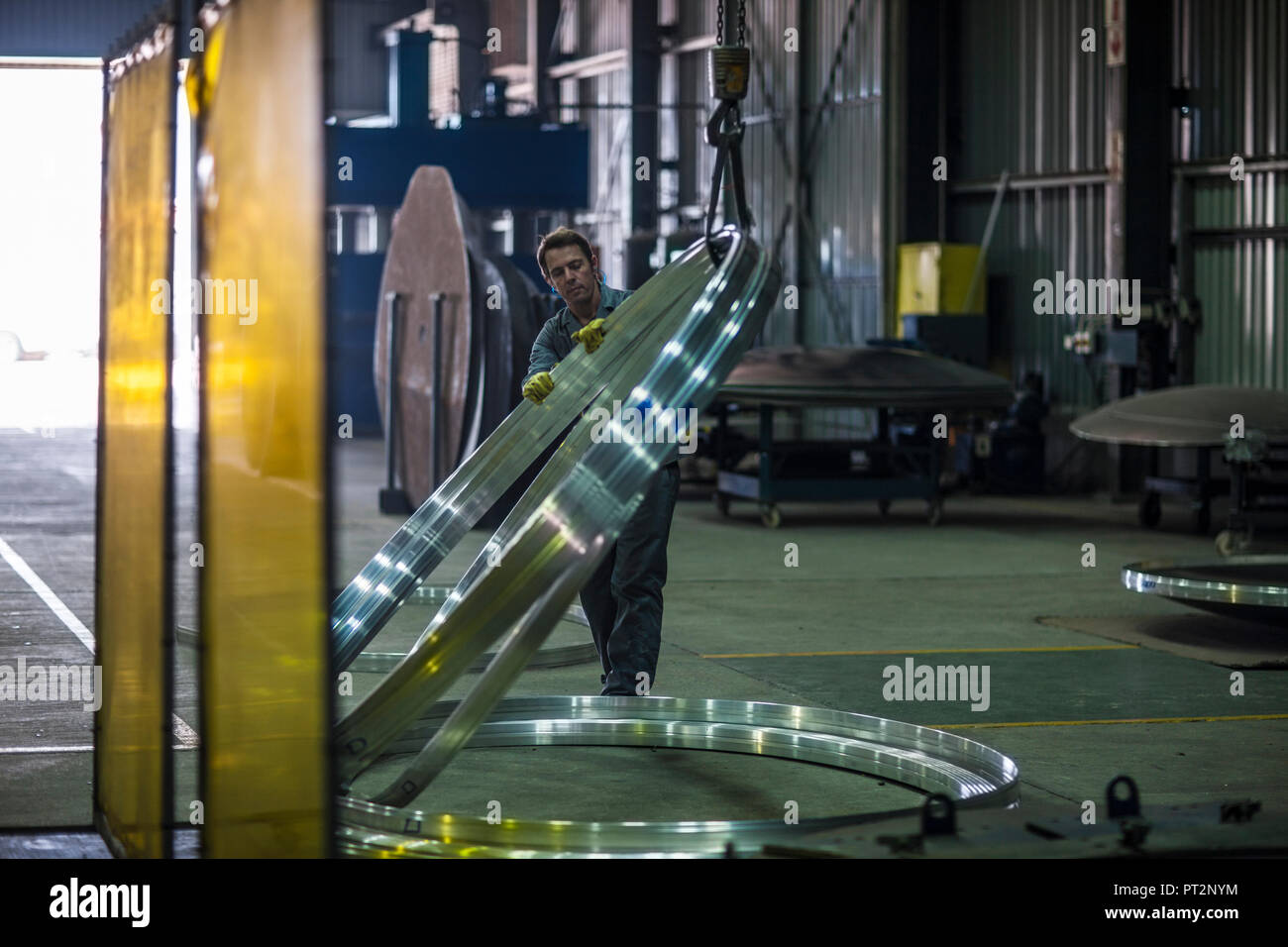 Worker working in steel factory Stock Photo - Alamy