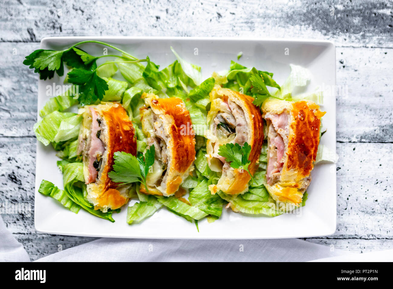 Swiss roll, puff pastry with sausage meat, cheese, onion, parsley and ...