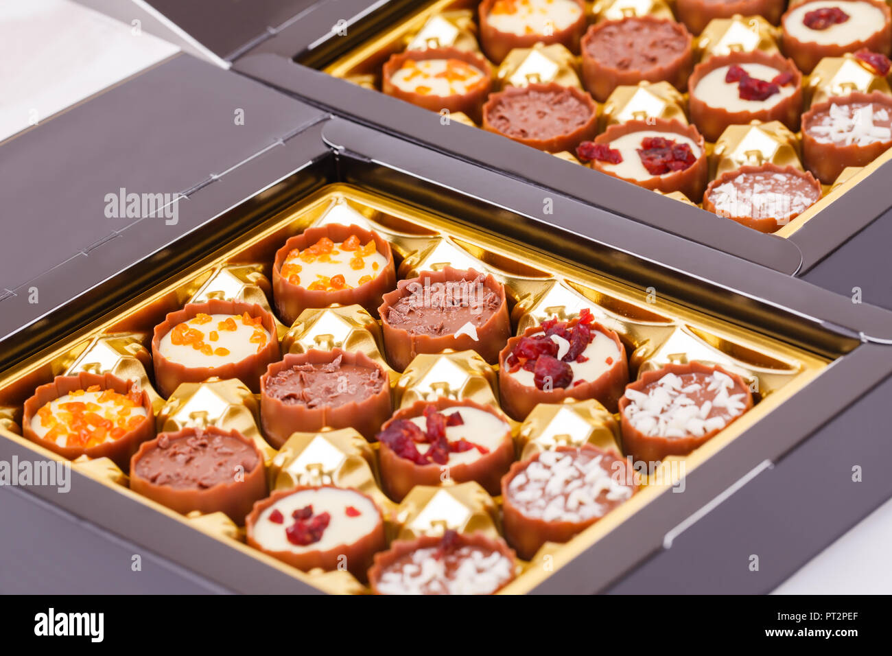 Assortment of chocolate in plastic boxes closeup picture Stock Photo ...