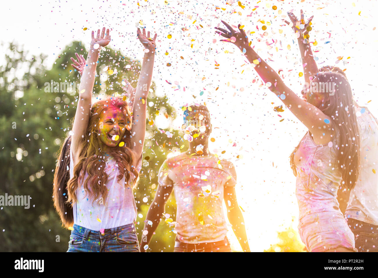 Group of happy friends playing with holi colors in a park - Young ...
