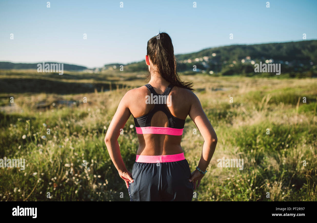 Portrait of a female jogger, rear view Stock Photo - Alamy