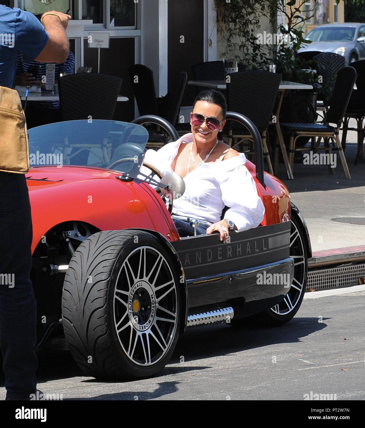 Kyle Richards arrives to meet Lisa Rinna in a three wheel Vanderhall ...