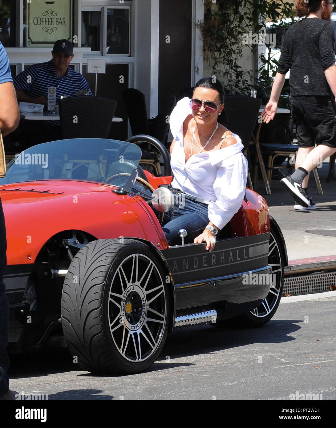 Kyle Richards arrives to meet Lisa Rinna in a three wheel Vanderhall ...