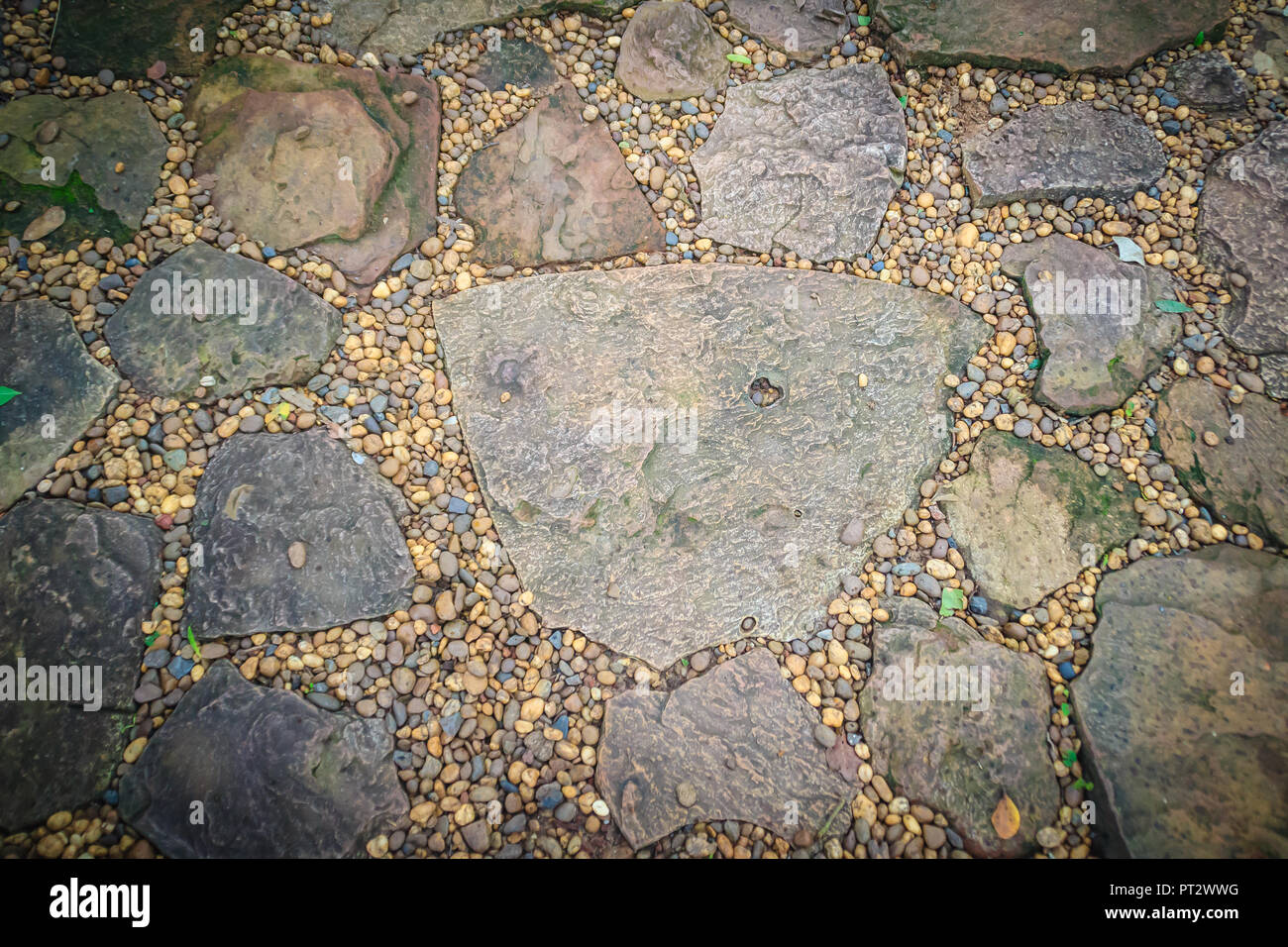 Vintage nature cobblestone and pebbles pavement in disorganized ...