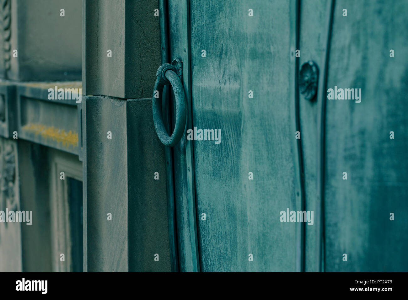 Heavy metal ring on an old steel door with patina hi-res stock ...