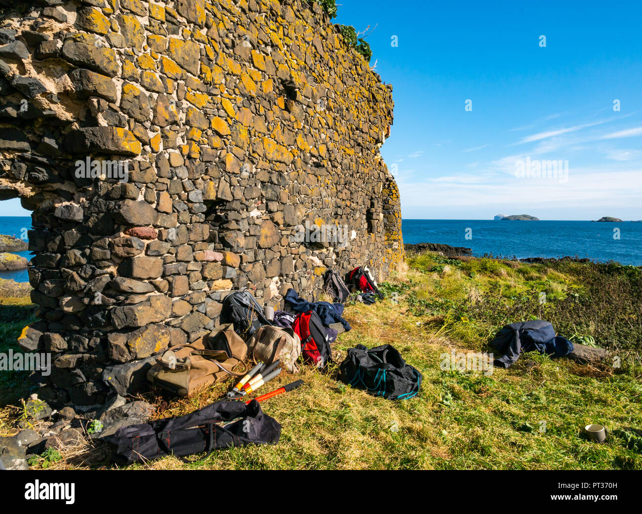 Tools and bags by ruin of lazaretto, Fidra Island with Firth of Forth ...