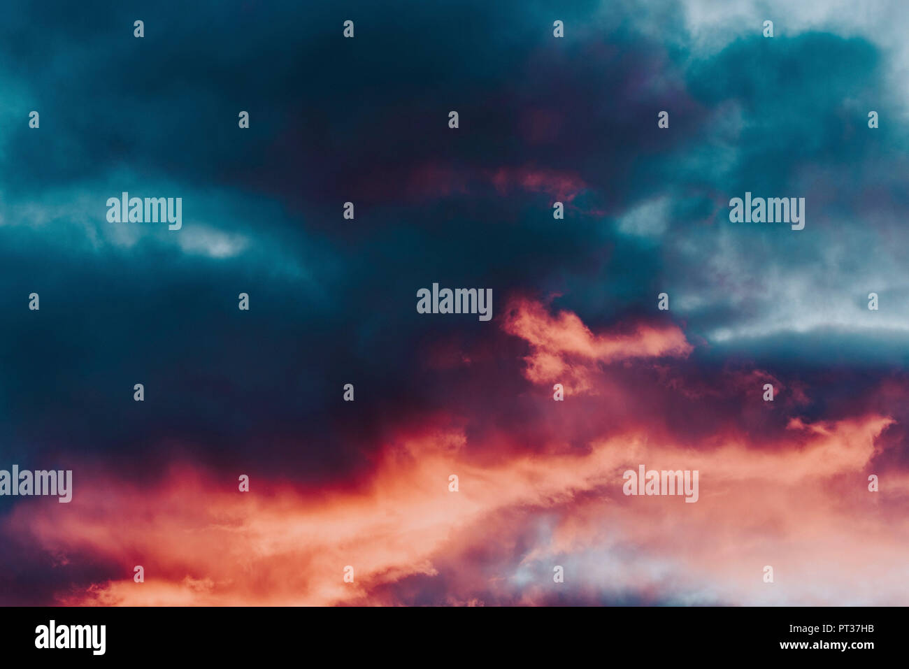 Red evening sun in clouds, blue red clouds Stock Photo - Alamy