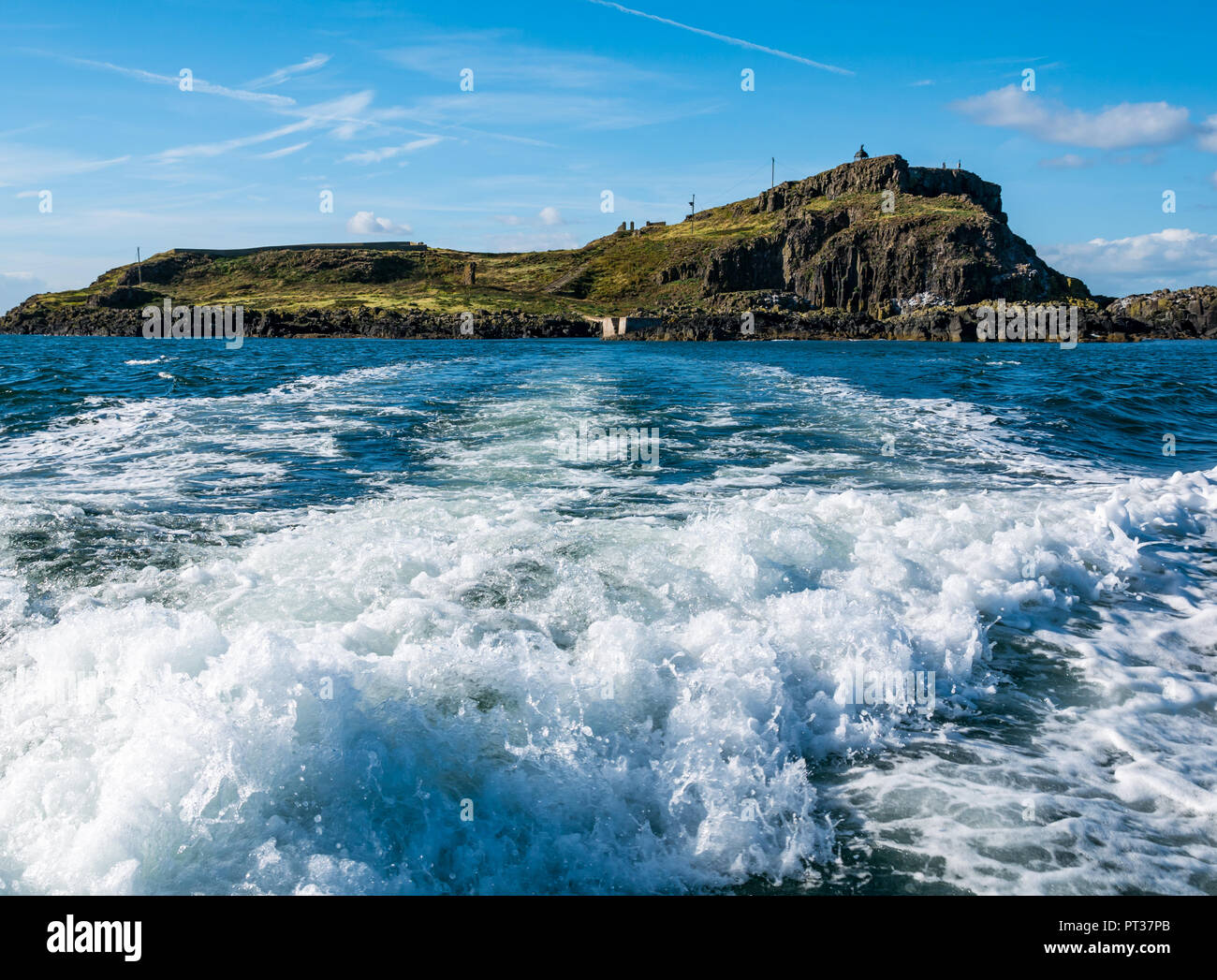 Speeding boat wake and view of Fidra Island, Firth of Forth, East ...