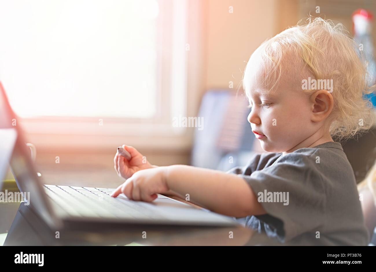 Baby playing with laptop computer Stock Photo - Alamy