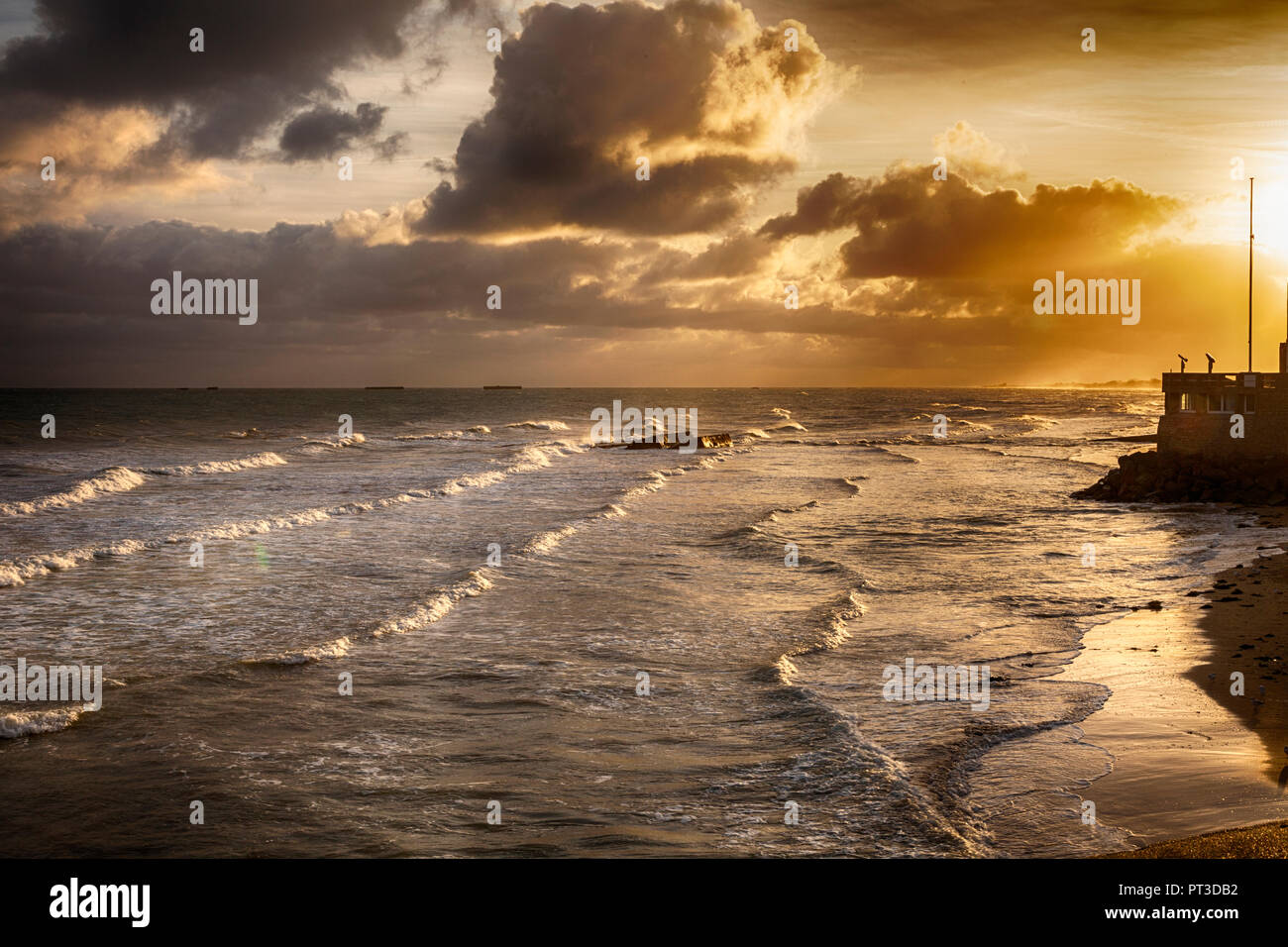 Arromanches, Normandy, Incoming Tide at Dawn, stormy Stock Photo - Alamy