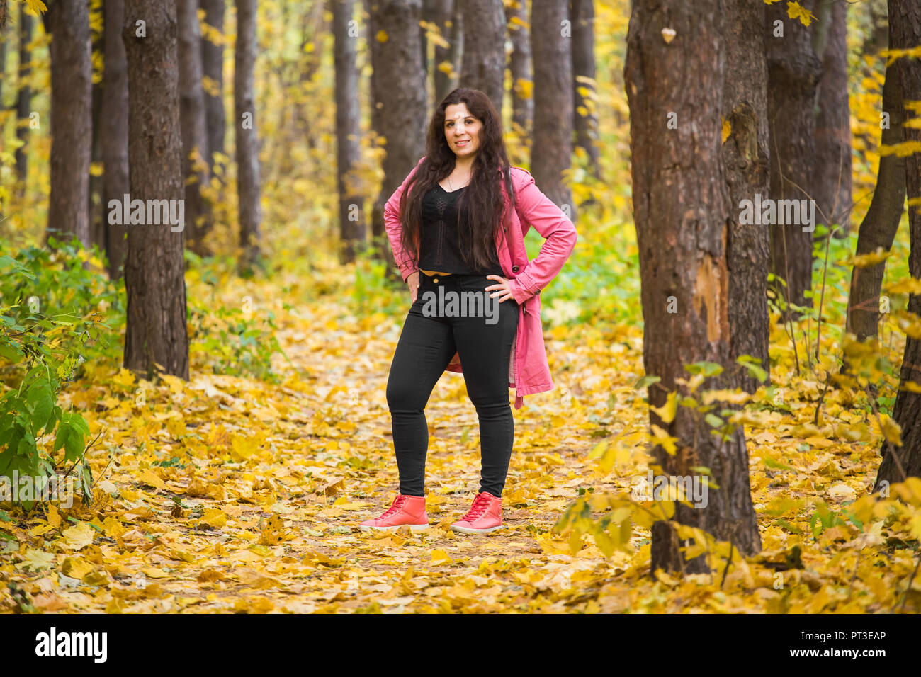 Weather, season, people concept - plus size woman in pink coat over the ...