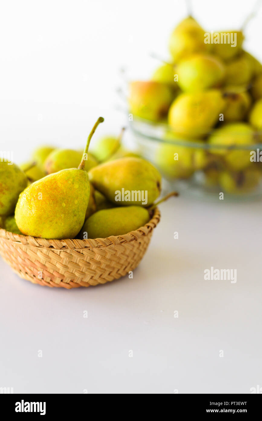 Fresh handpicked pears on white table. Bowl on background Stock Photo ...
