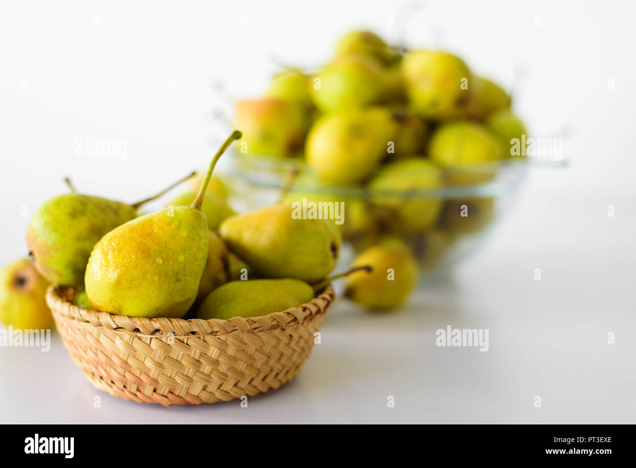 Fresh handpicked pears on white table. Bowl on background Stock Photo ...
