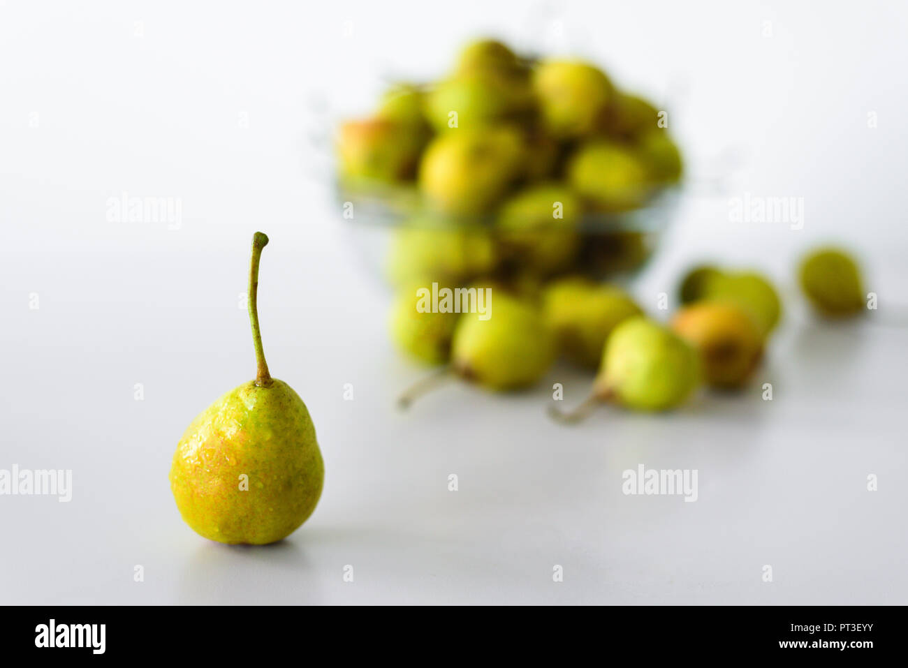 Fresh handpicked pears on white table. Bowl on background Stock Photo ...