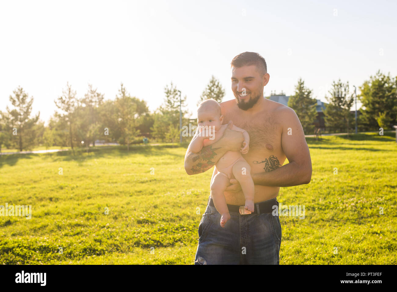 Happy father holding baby son on nature. Concept of happy family ...