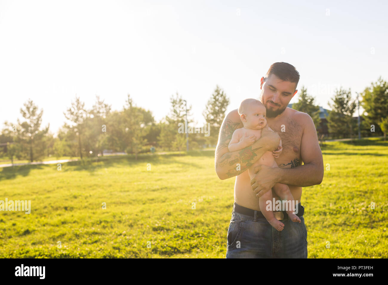 Happy father holding baby son on nature. Concept of happy family ...