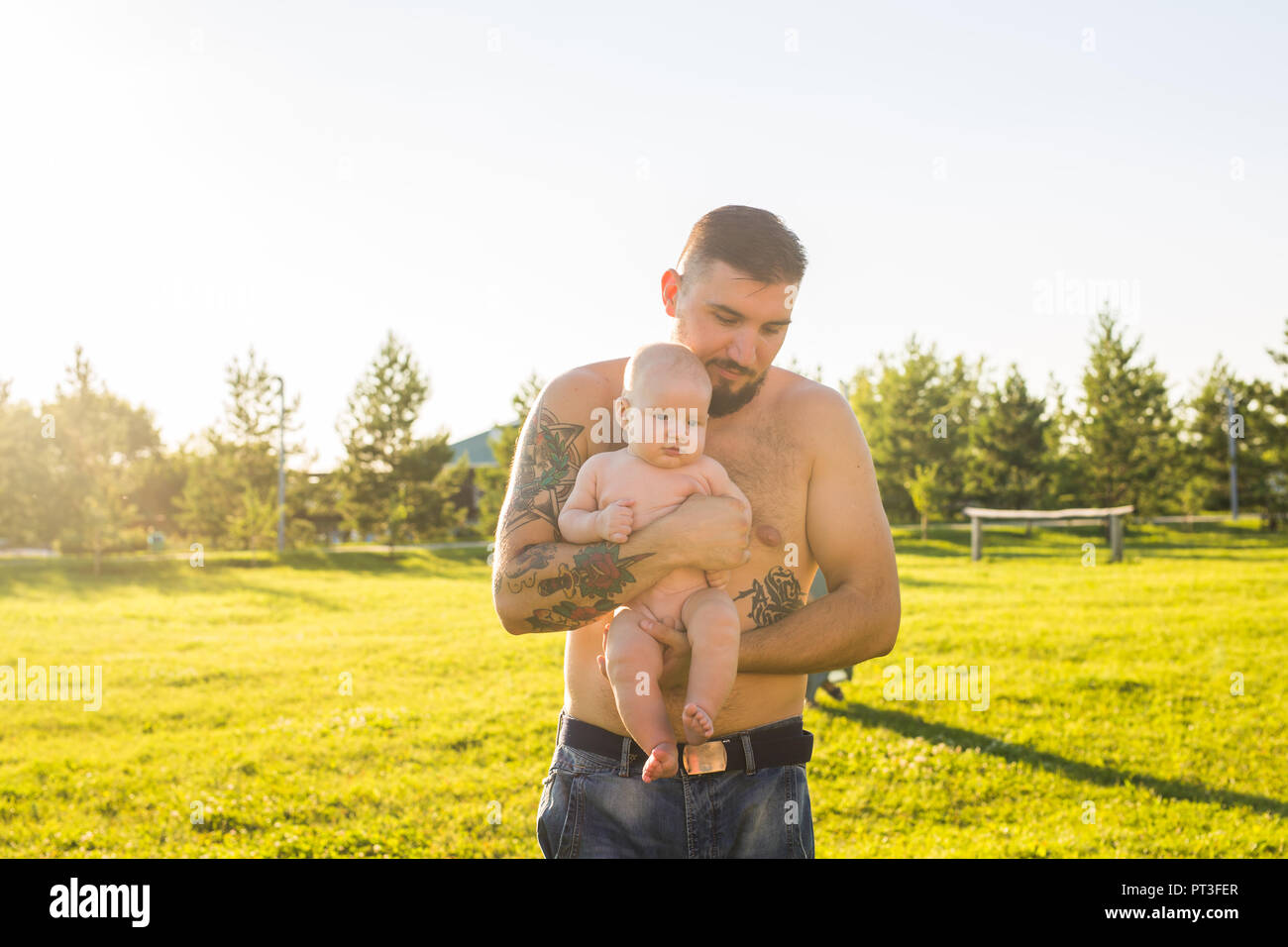 Happy father holding baby son on nature. Concept of happy family ...