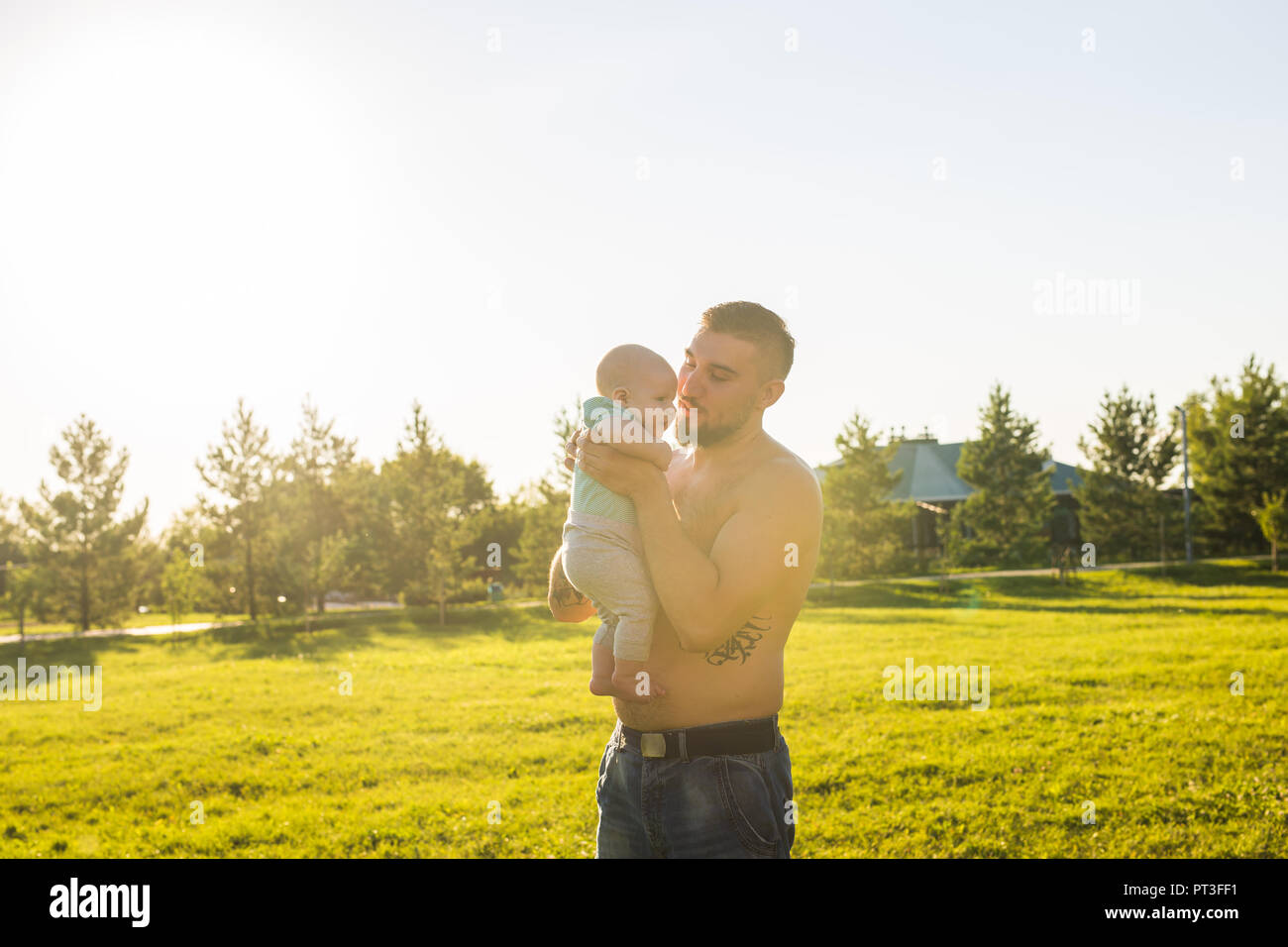 Happy father holding baby son on nature. Concept of happy family ...