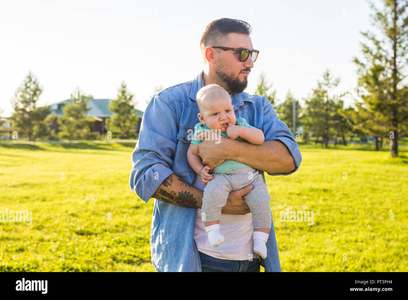 Happy father holding baby son on nature. Concept of happy family ...
