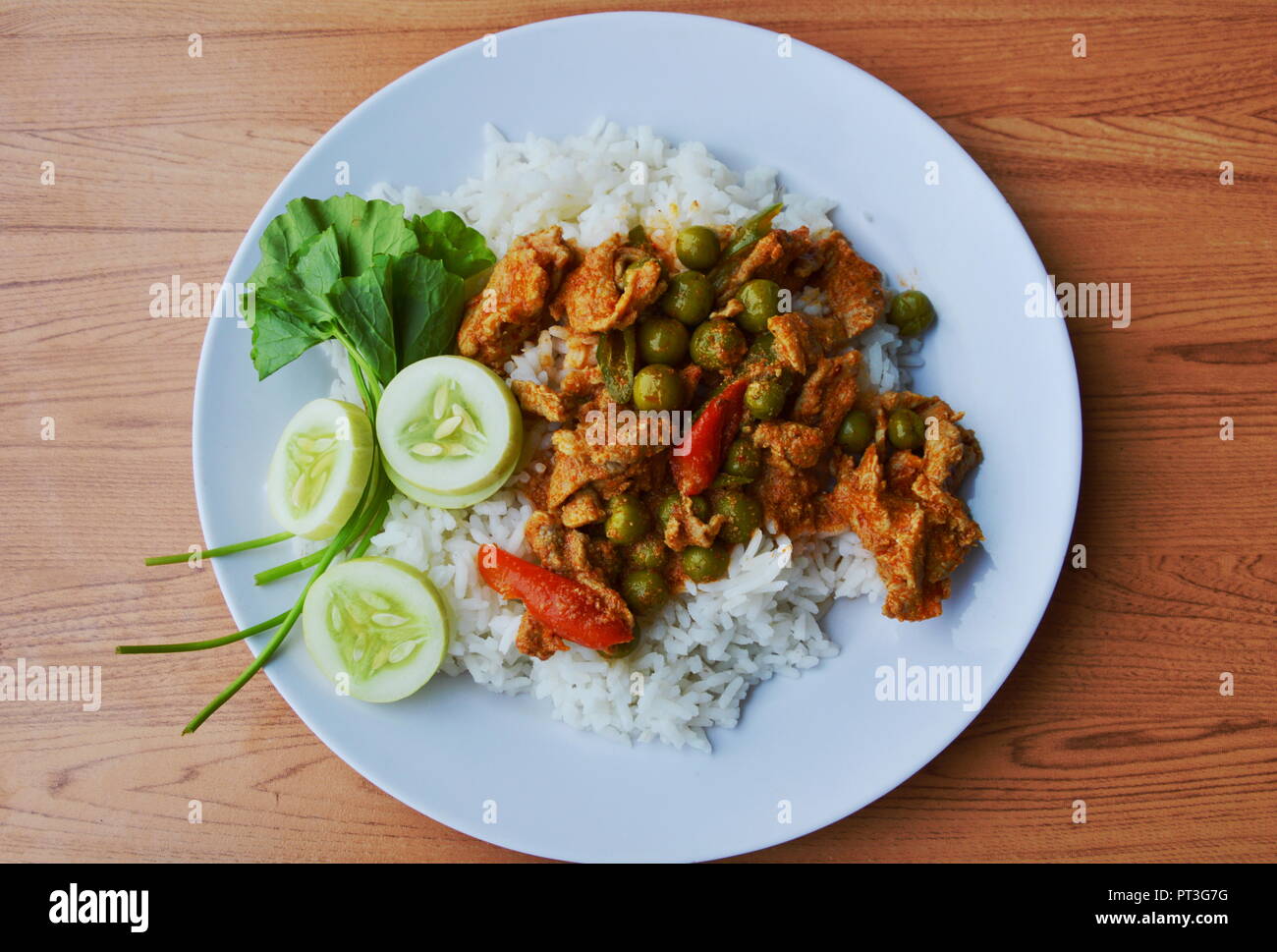 savory curry with pork on plain rice Stock Photo - Alamy