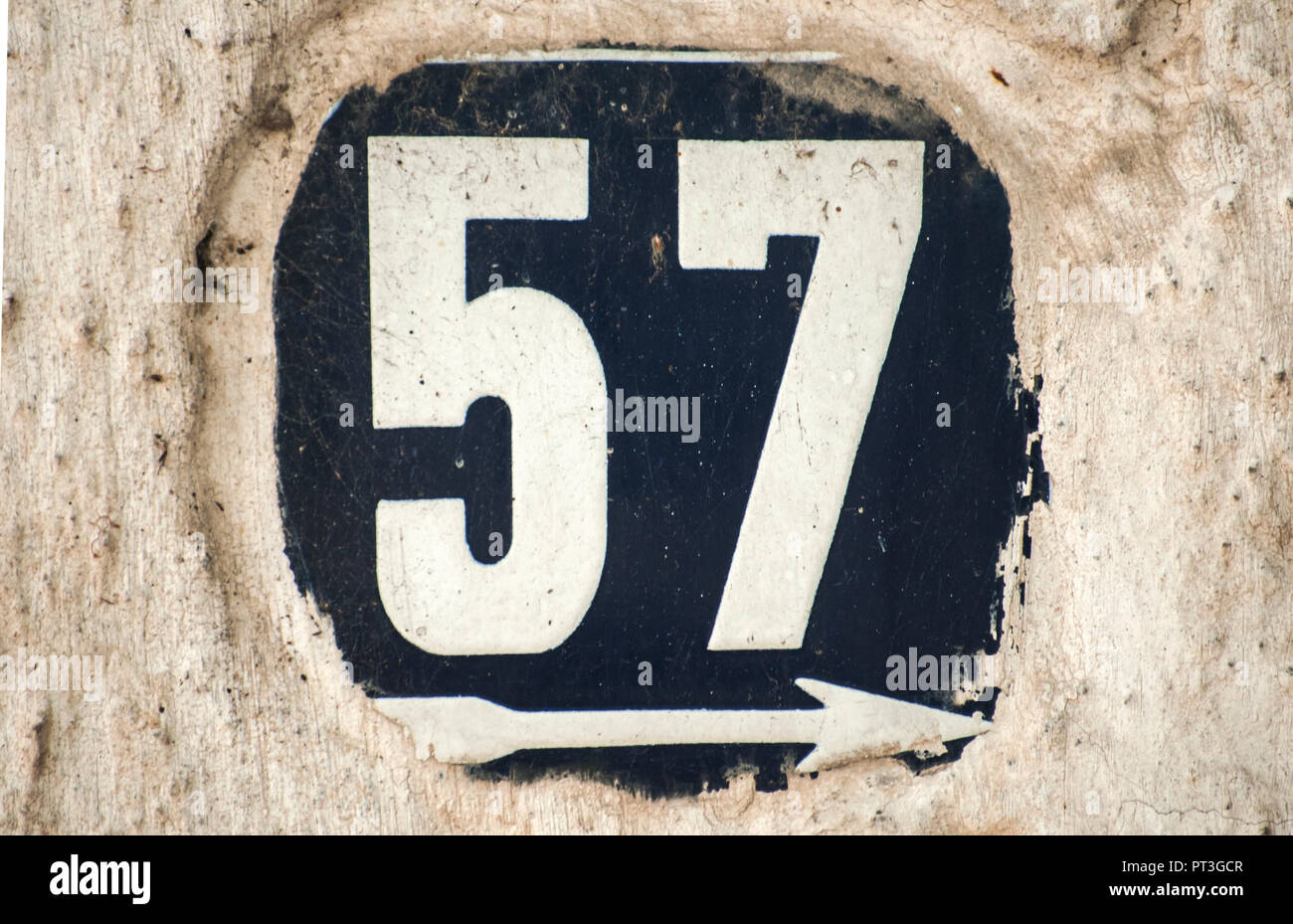 Weathered grunge square metal enameled plate of number of street ...