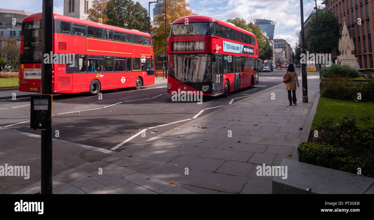 Two red London buses pass in opposite directions near St Paul's ...
