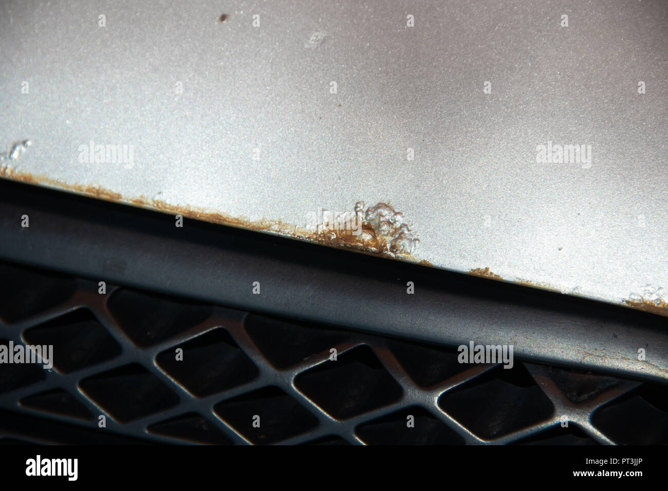 Rust on the bonnet of a silver car with black radiator grille Stock ...