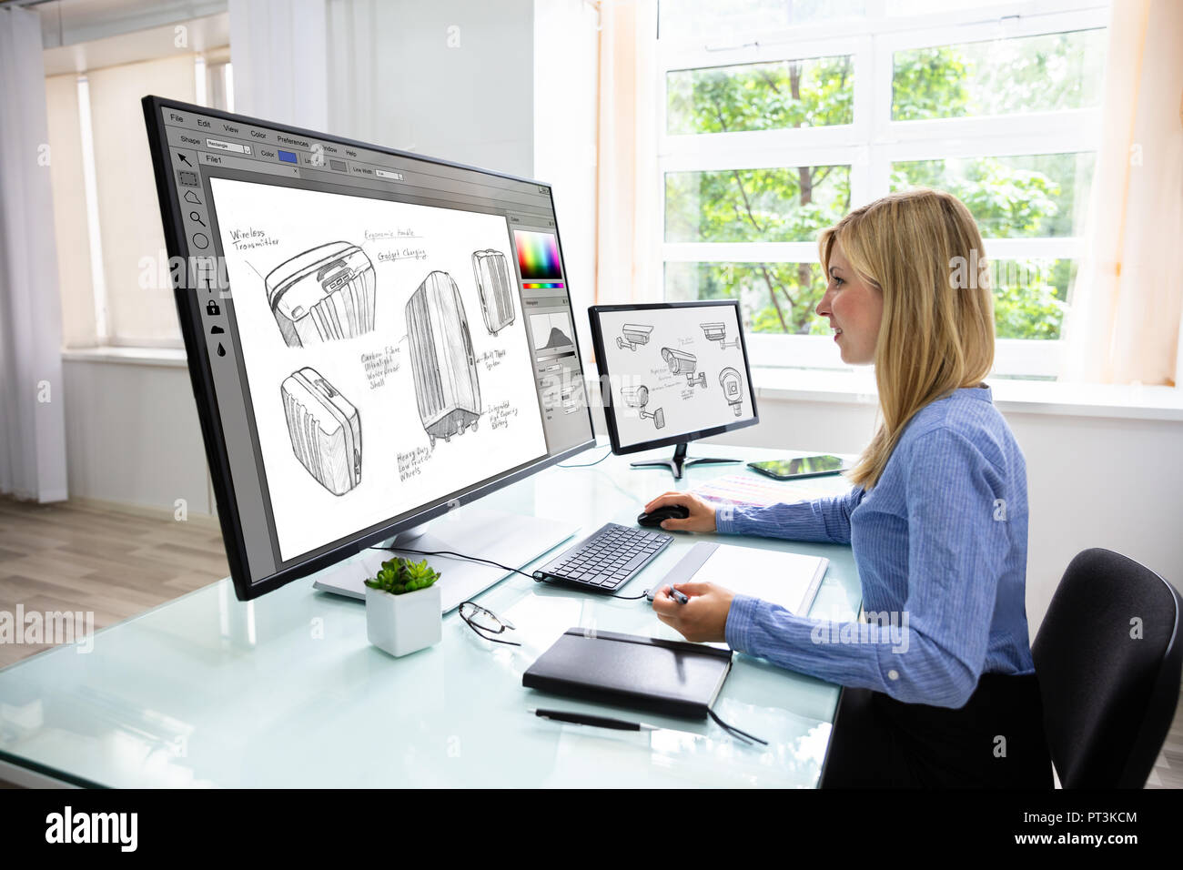 Side View Of A Young Female Designer Using Graphic Tablet While Working ...