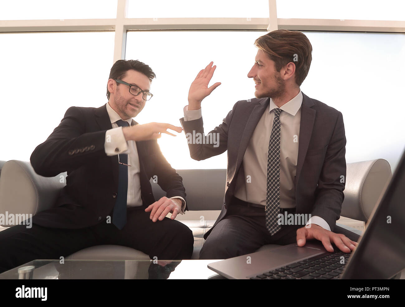 two businessmen giving each other a high five.success concept Stock ...
