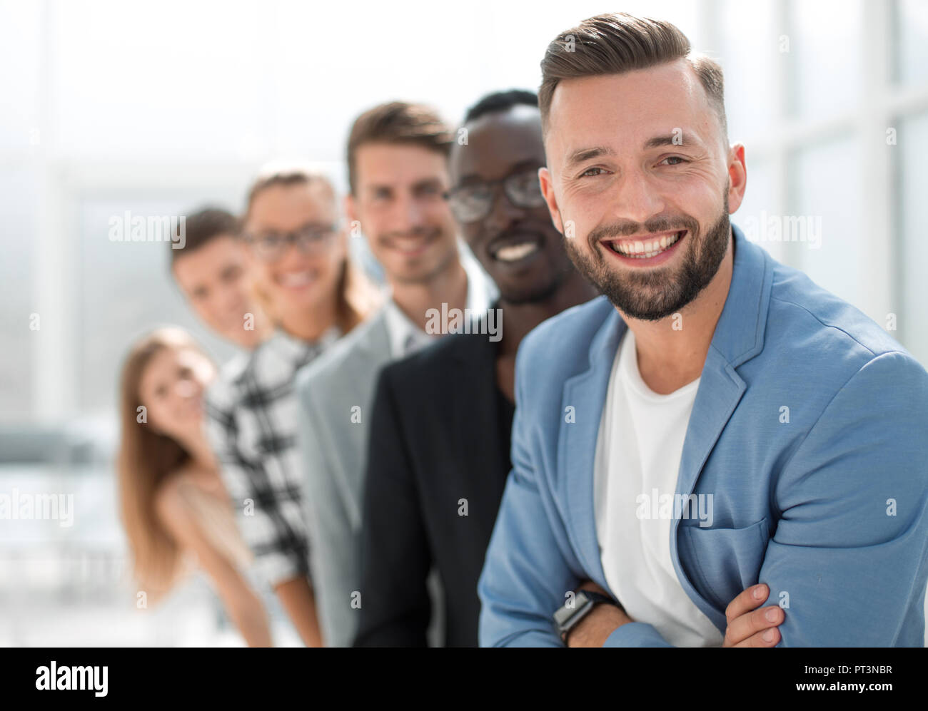 Happy smiling group of friends standing together in a row isolated on ...